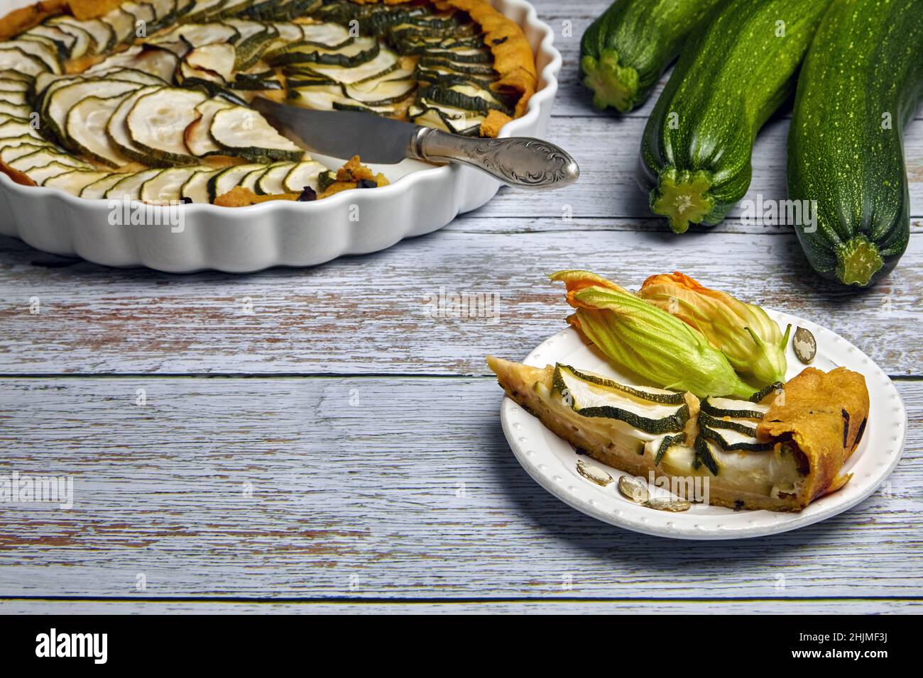 Slice of an open cake from sliced zucchini in a cheese fill with ...