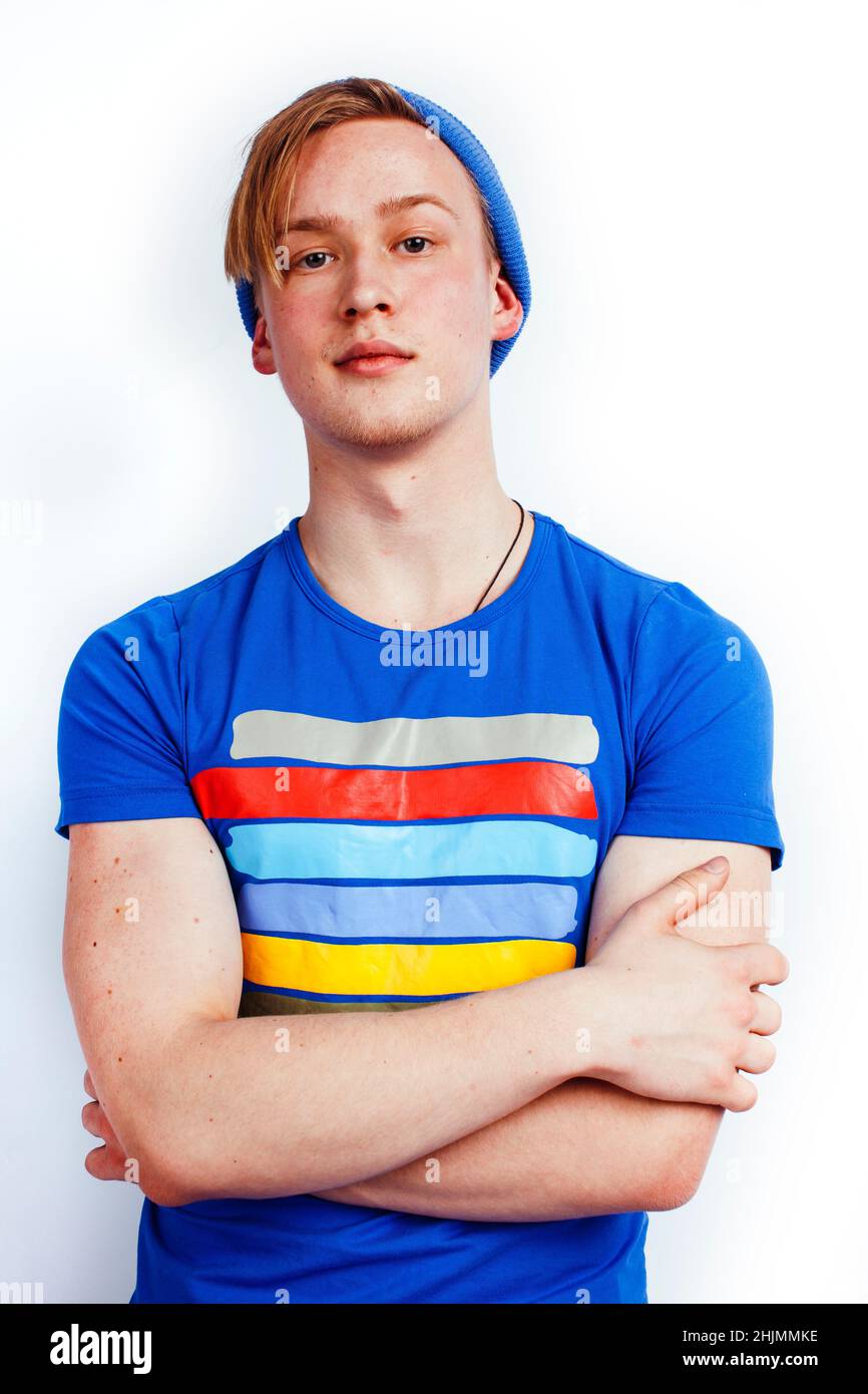 young handsome teenage hipster guy posing emotional, happy smiling against white background ...