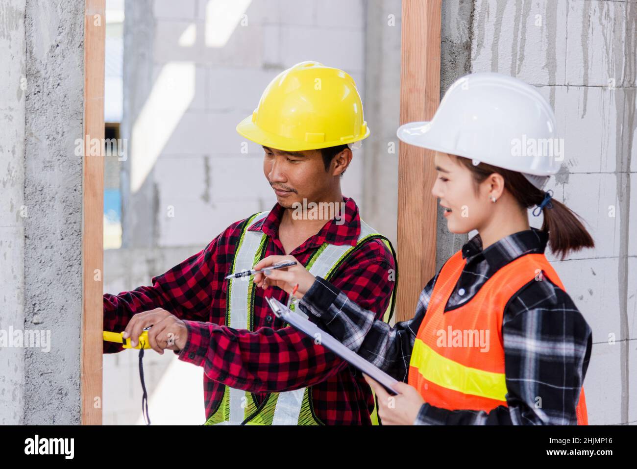 Male industrial builder workers installation process measuring wooden ...