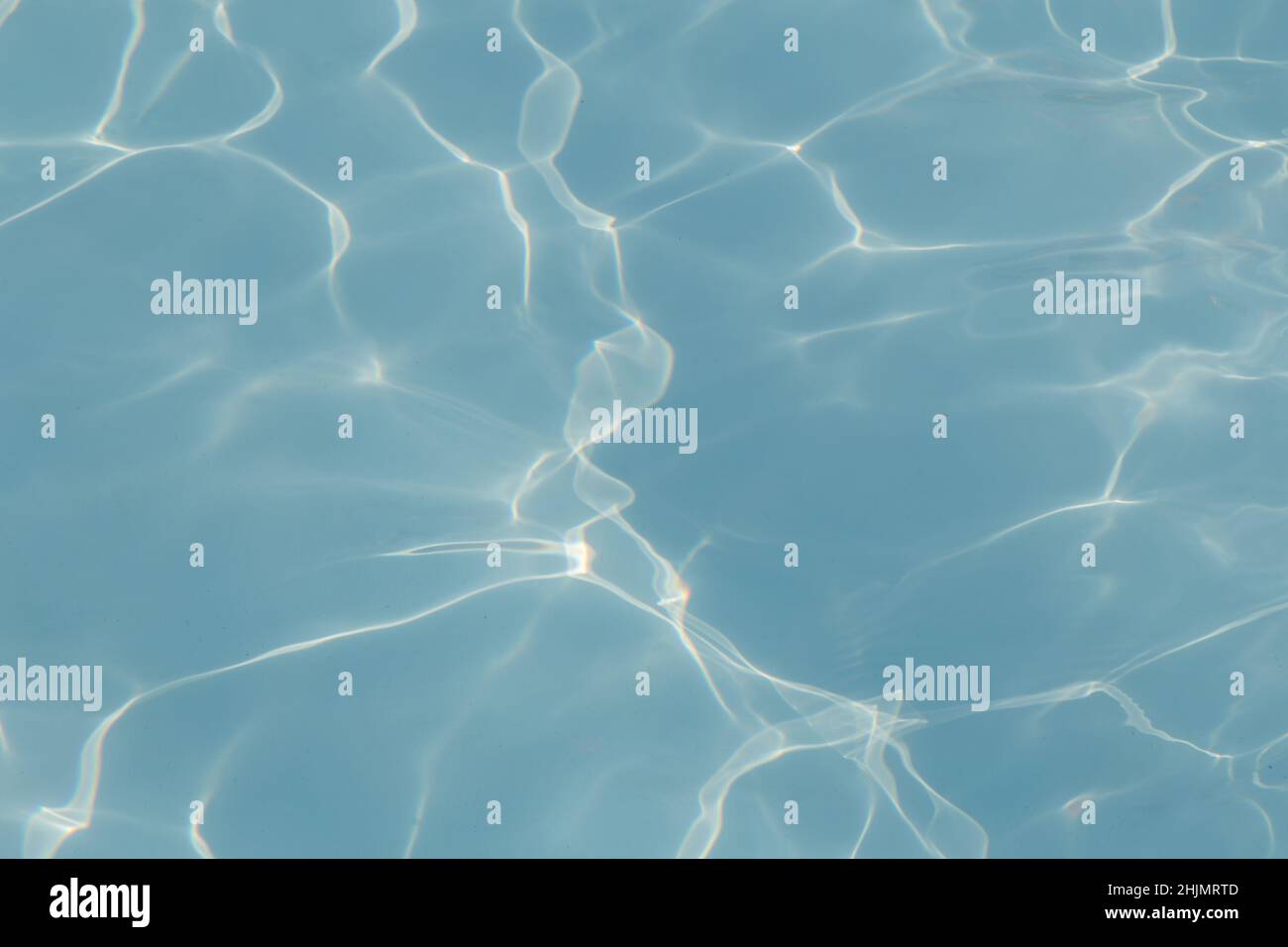 Blue pool water with sun reflections background Stock Photo - Alamy