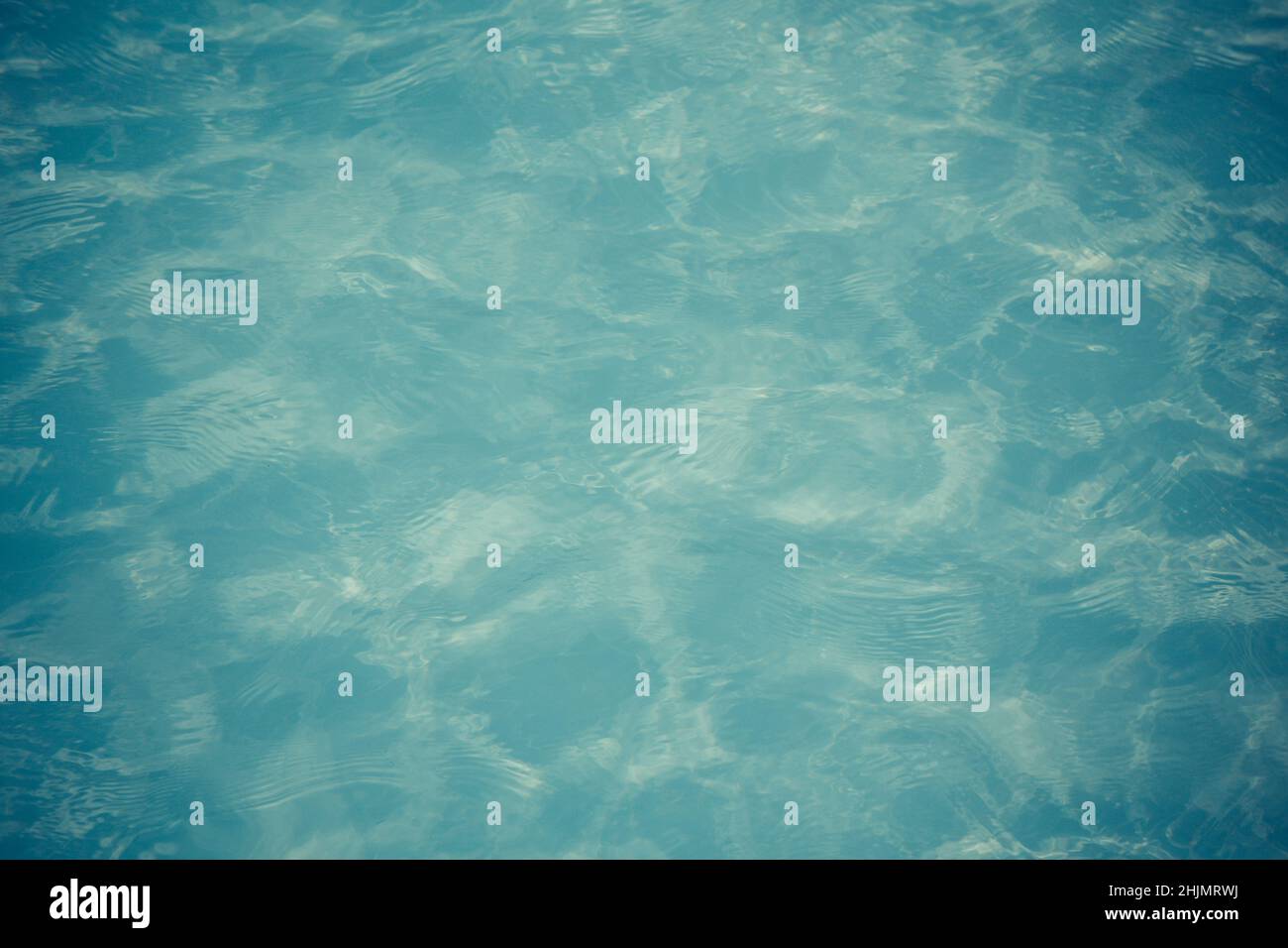 Blue pool water with sun reflections background Stock Photo - Alamy