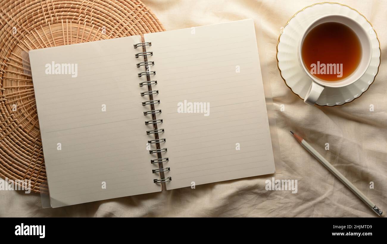 Empty spiral notebook page for your text or graphic and a ceramic tea ...