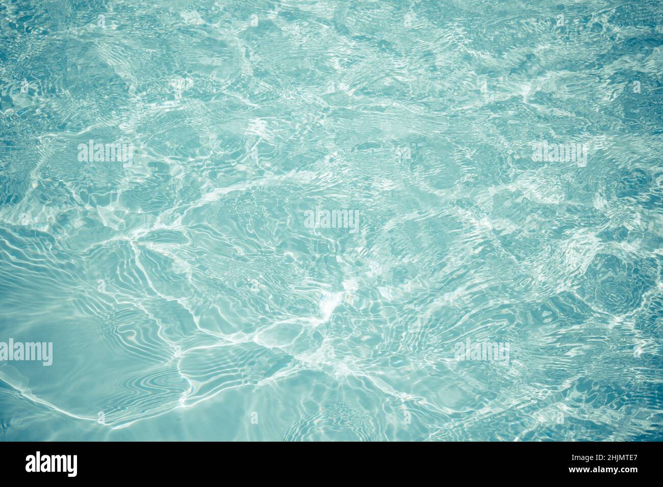 swimming pool with sunny reflections background Stock Photo - Alamy