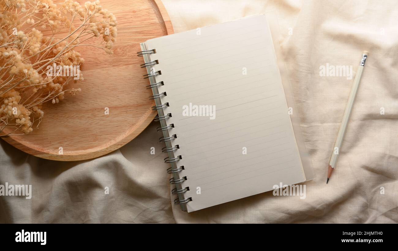 A spiral notebook with an empty cover page in a cozy minimal decorative ...