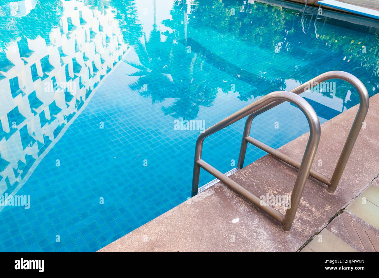 Grab bars ladder in the blue swimming pool background Stock Photo - Alamy