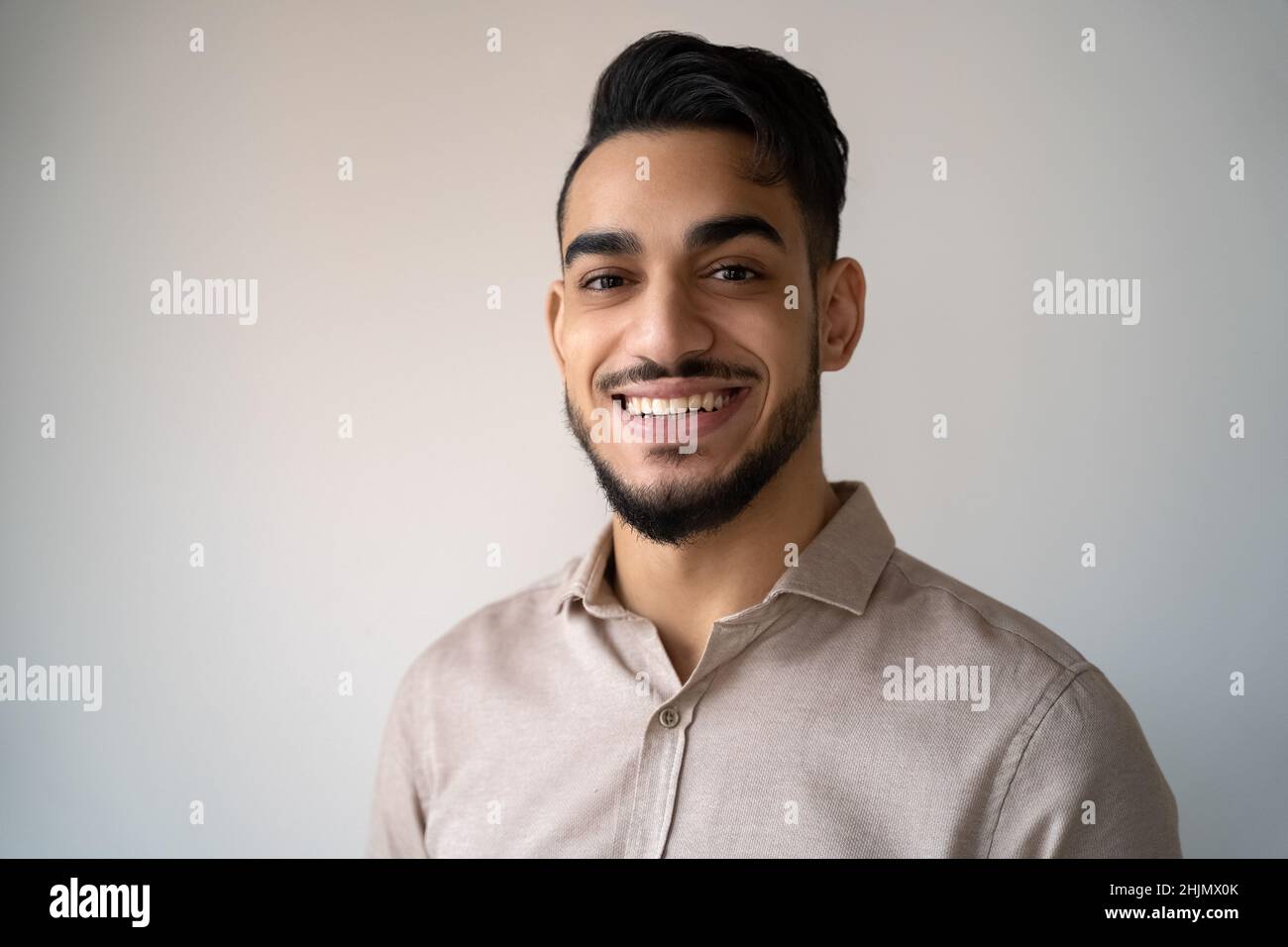 Headshot portrait of young adult smiling Indian man over blank copy ...