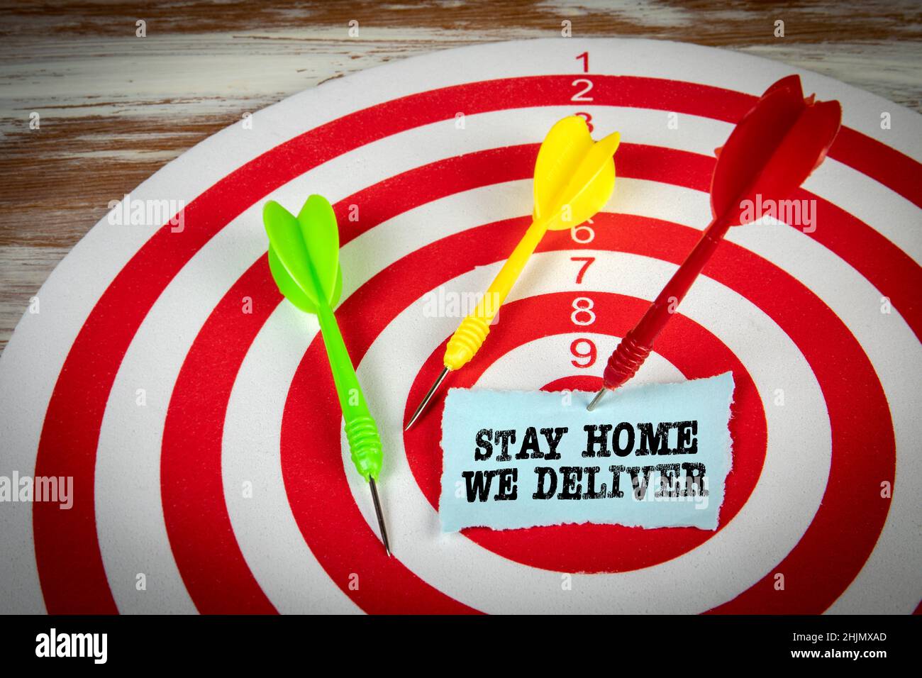 STAY HOME WE DELIVER. Red target with darts Stock Photo - Alamy