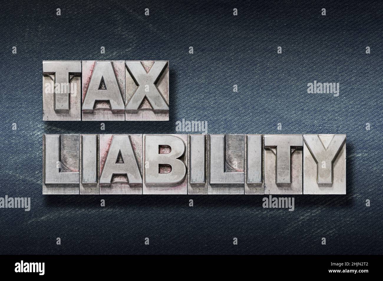tax liability phrase made from metallic letterpress on dark jeans ...