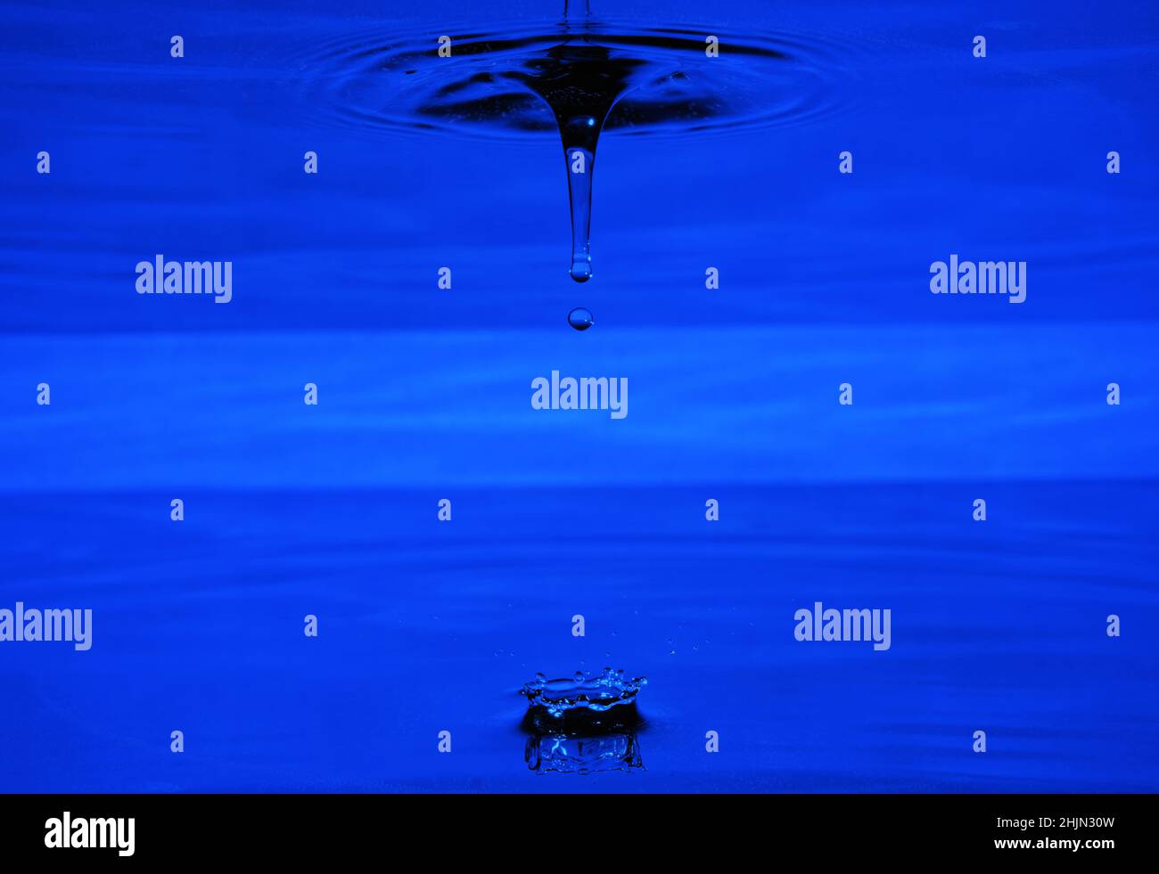 Water droplets dripping from above and below. Water splashes after a ...