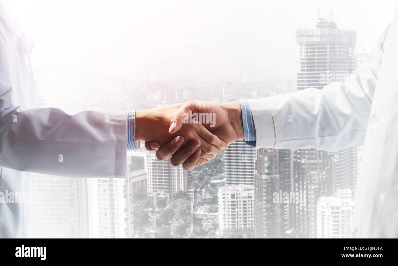 Handshake between nurse doctor hi-res stock photography and images - Alamy
