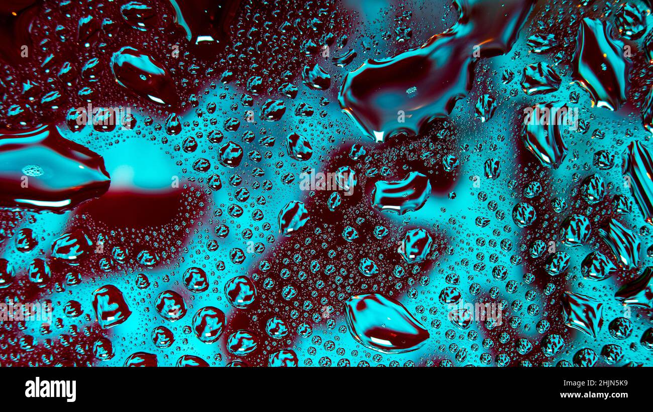 Water drops on a glass reflecting blue color Stock Photo - Alamy