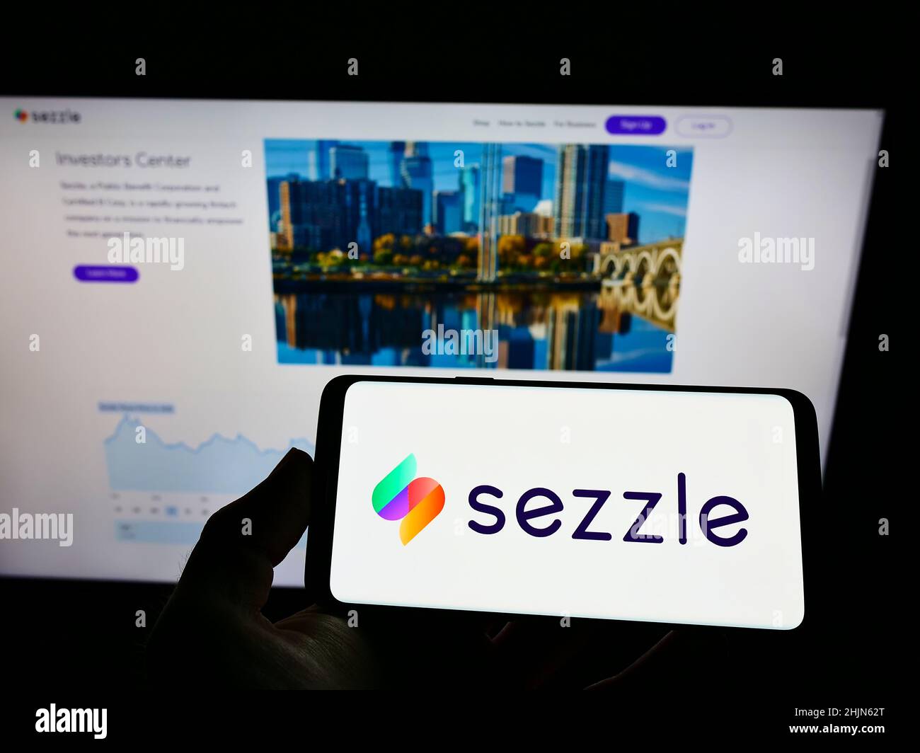 Person holding mobile phone with logo of US financial technology ...