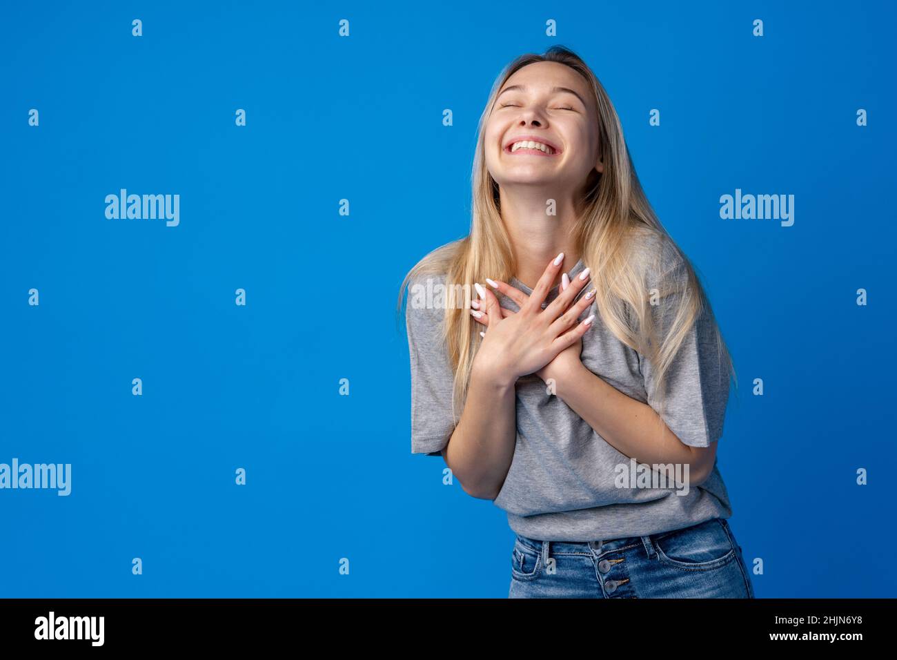 Happy smiling pretty teenage girl laughing over blue background Stock ...