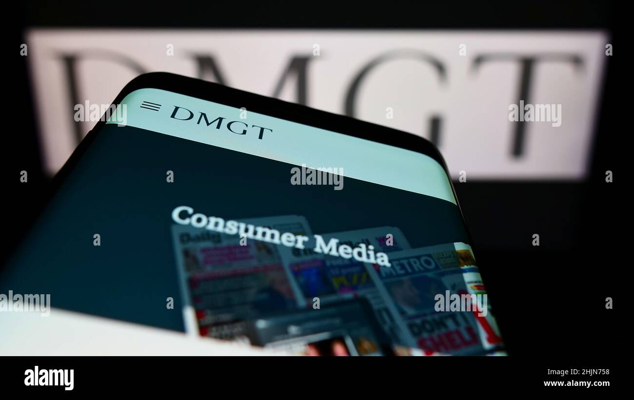 Smartphone with website of company Daily Mail and General Trust plc (DMGT) on screen in front of ...