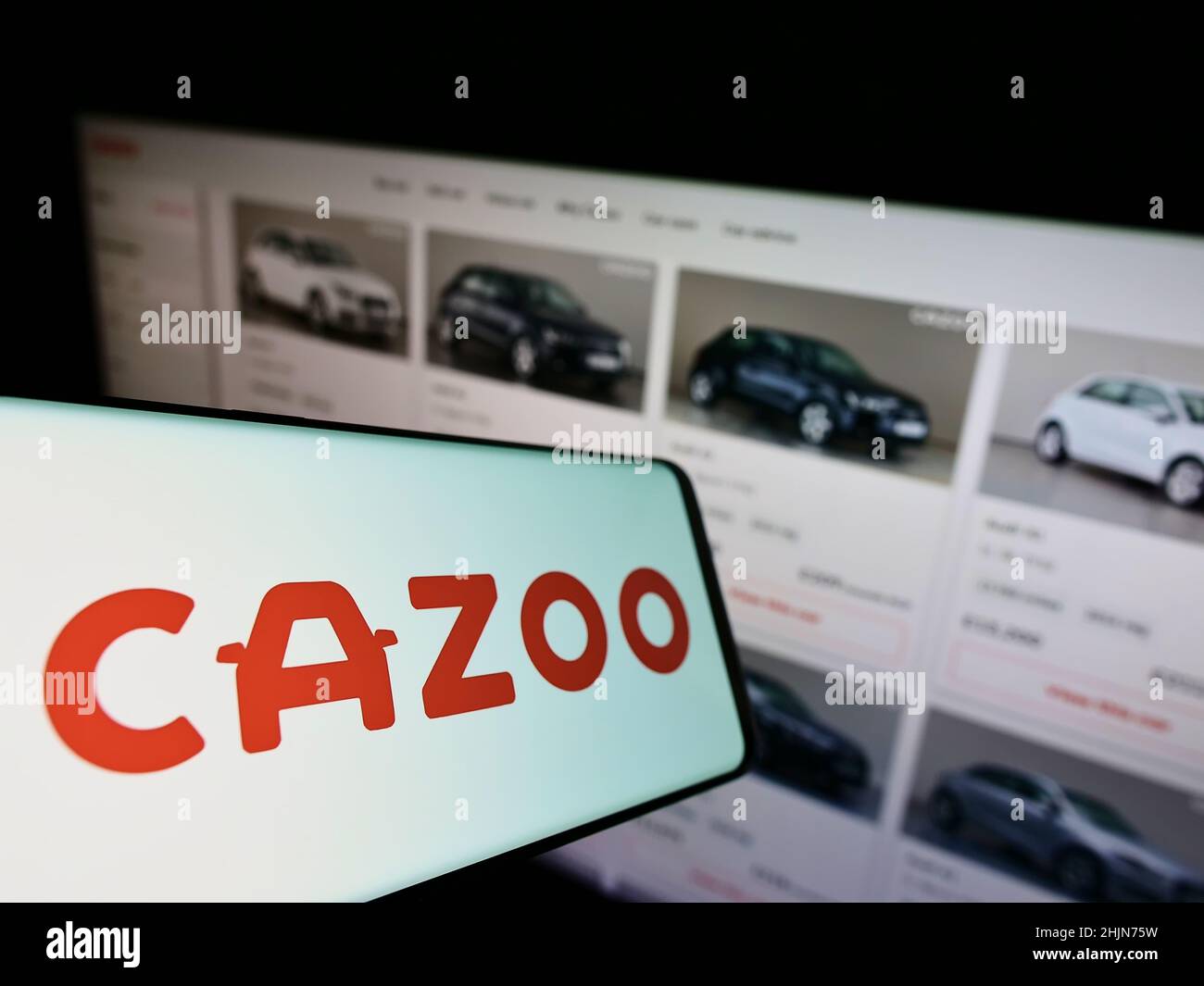Cellphone with logo of British car retailing company Cazoo Ltd. on ...