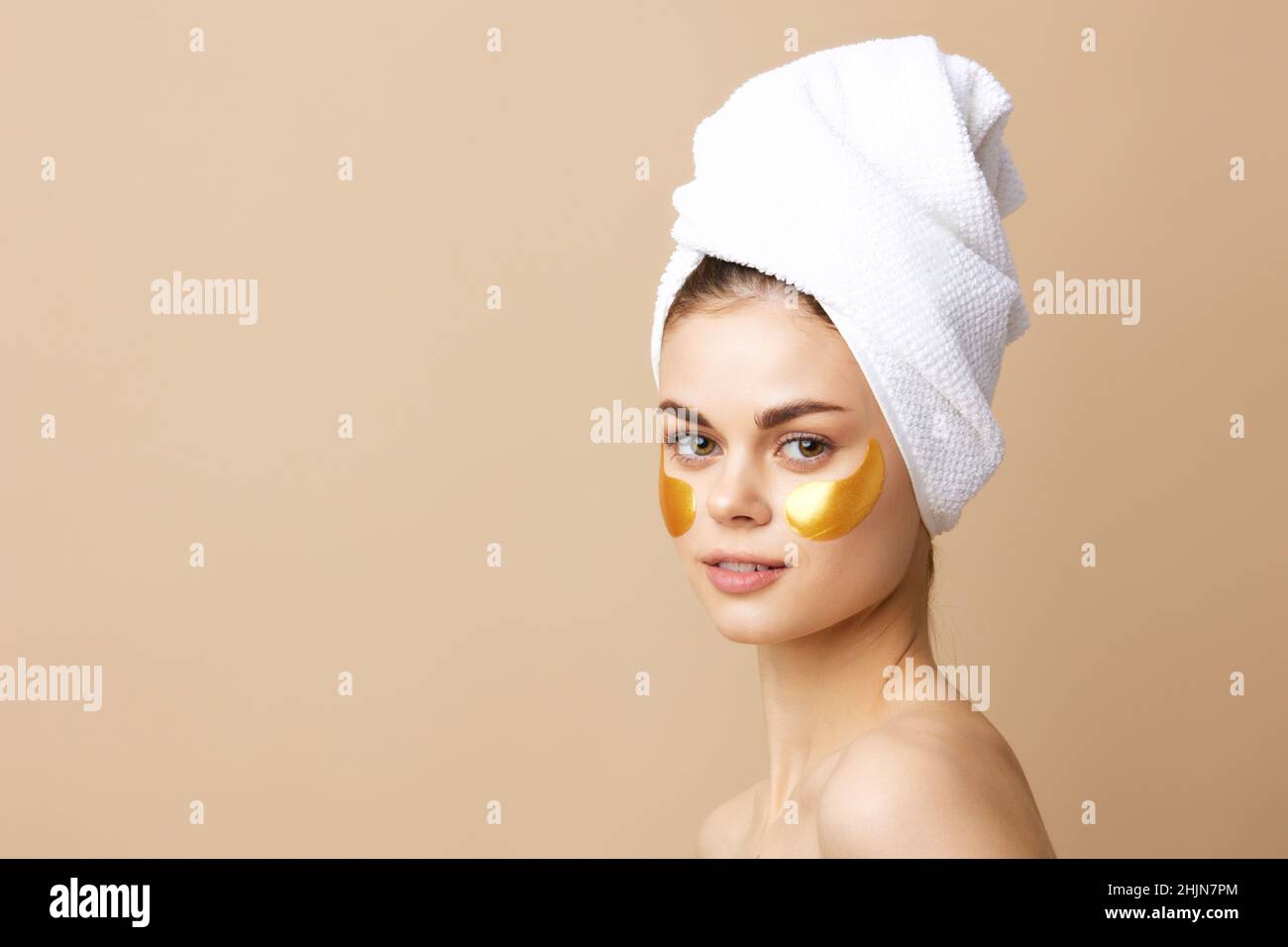 woman patches rejuvenation skin care fun after shower beige background ...