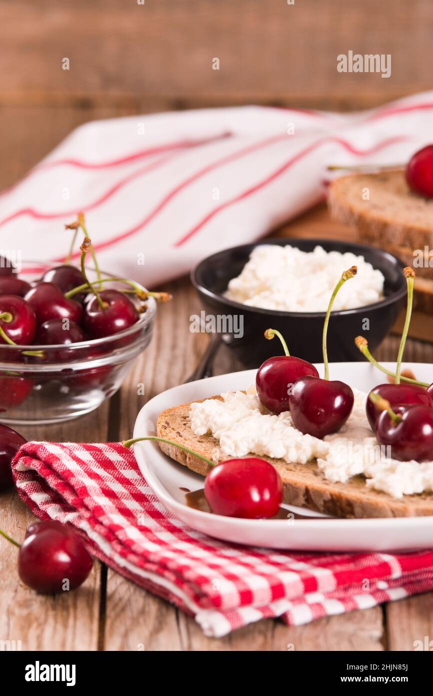 Rye bread with cottage cheese and cherries Stock Photo - Alamy
