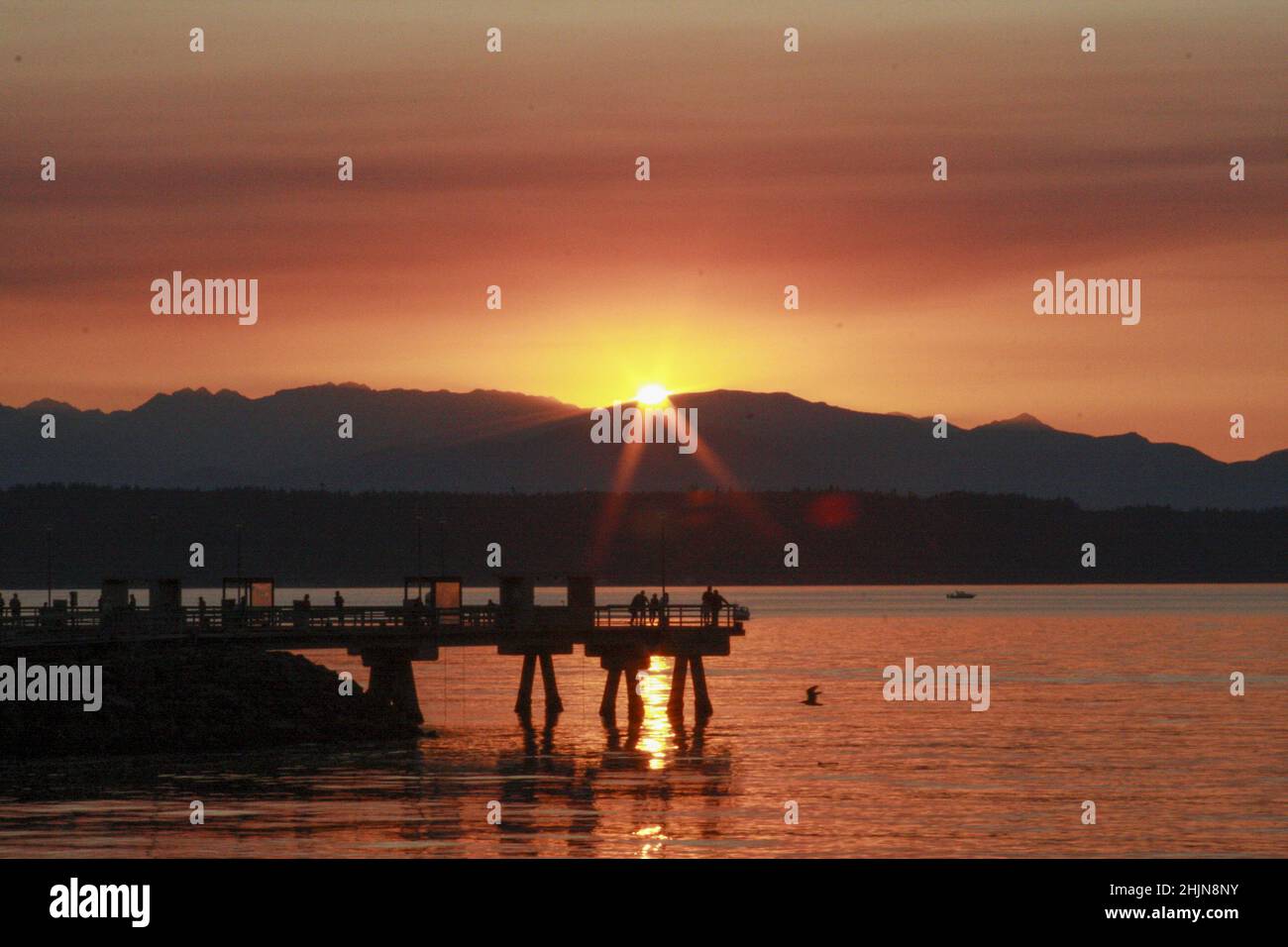 Landscape of a dock on the Puget Sound during a beautiful sunset in ...