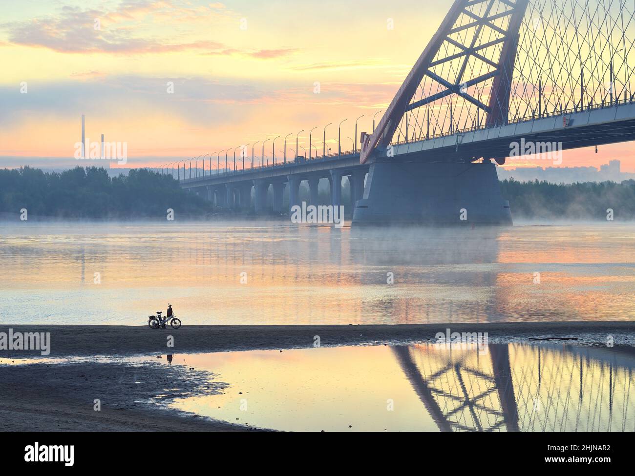 Bike on the beach. Car bugrinskij bridge across the great Siberian ...