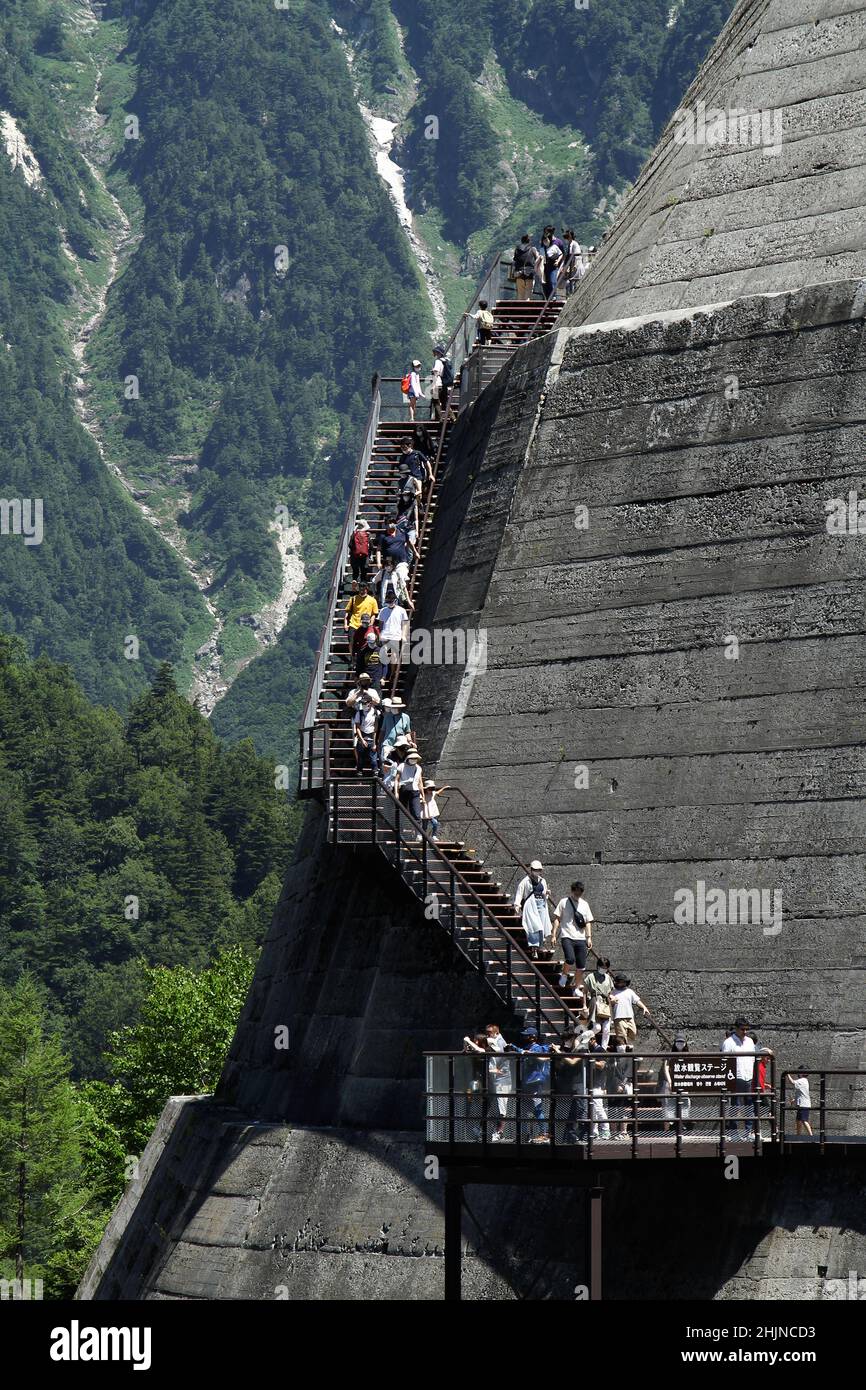 Nagano, Japan, 2021-23-07 , people climbing the cement wall to reach a ...