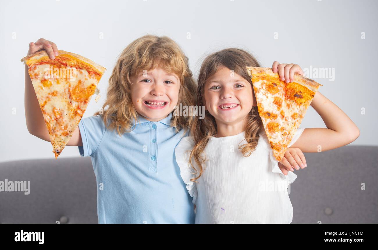 Children eating pizza. Happy excited children eating pizza and having ...