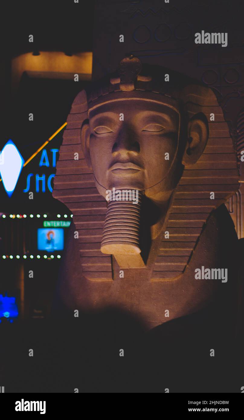 Vertical shot of The Sphinx surrounde by lights at night in Las Vegas ...