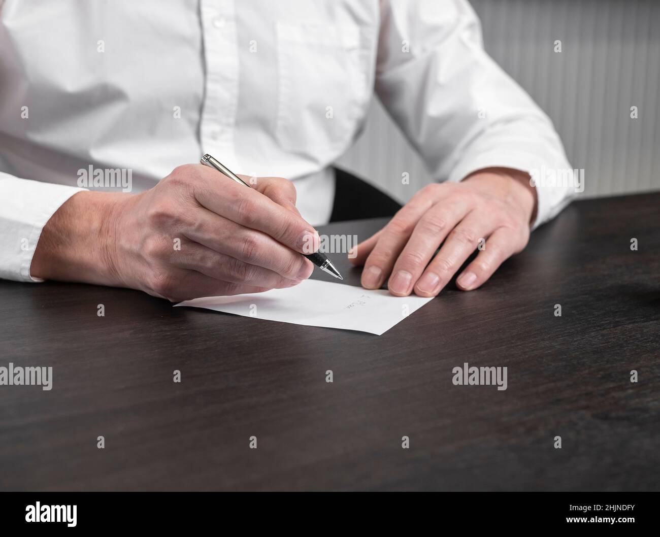 Man hands taking memo notes. Businessman sitting at desk and writing ...