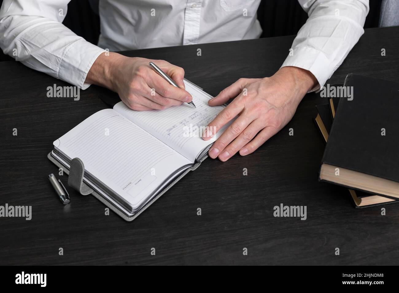 Man holding book and pen hi-res stock photography and images - Alamy