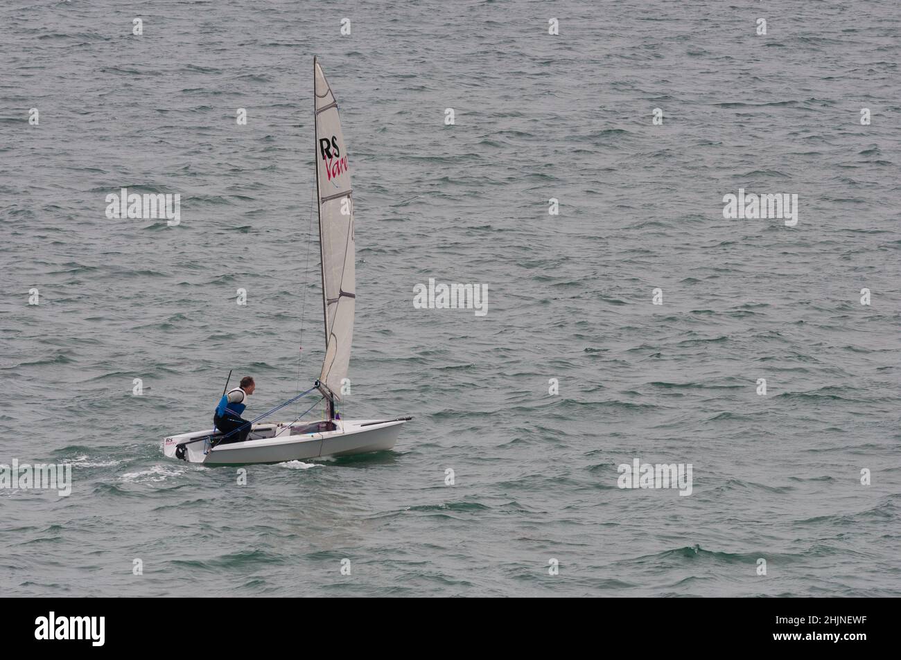Man sailing a RS Vareo single handed sailing dinghy on the Solent ...