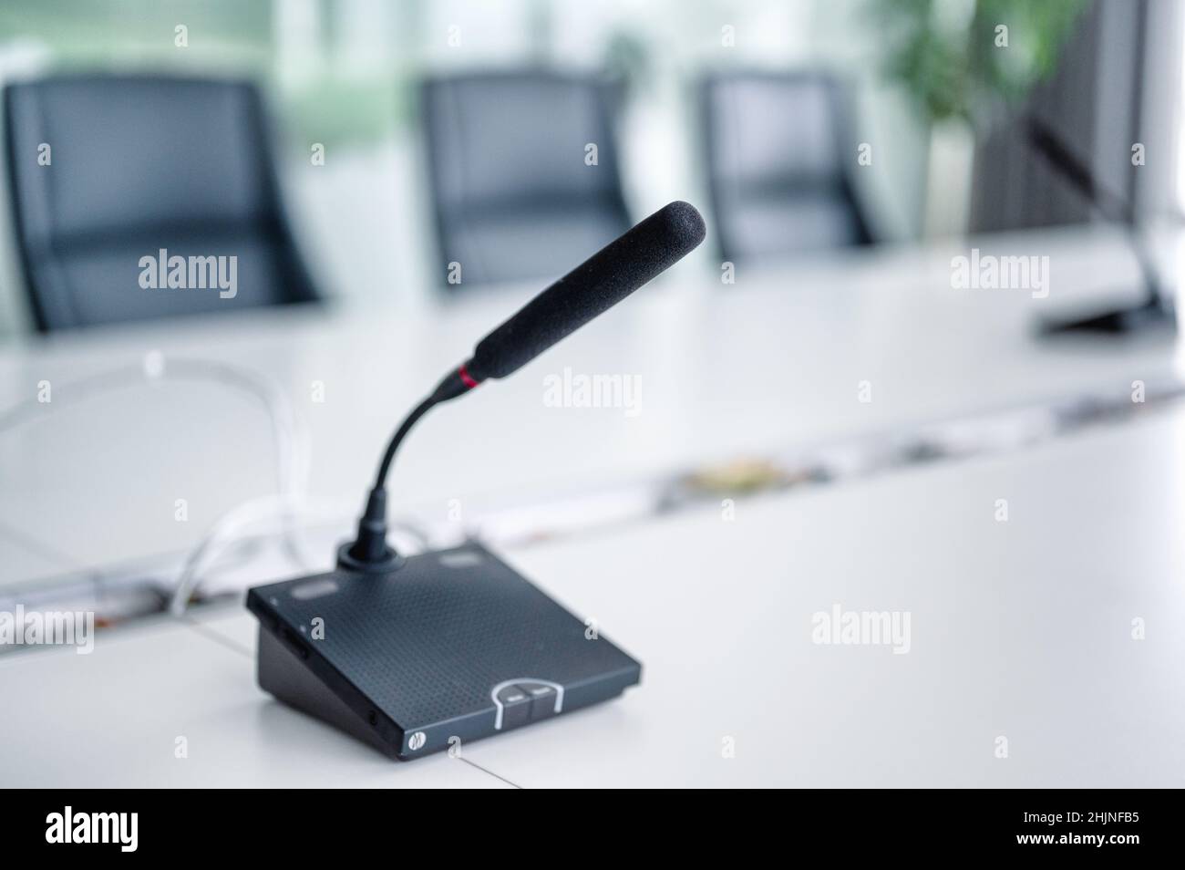 Black thin microphone on conference room table Stock Photo - Alamy