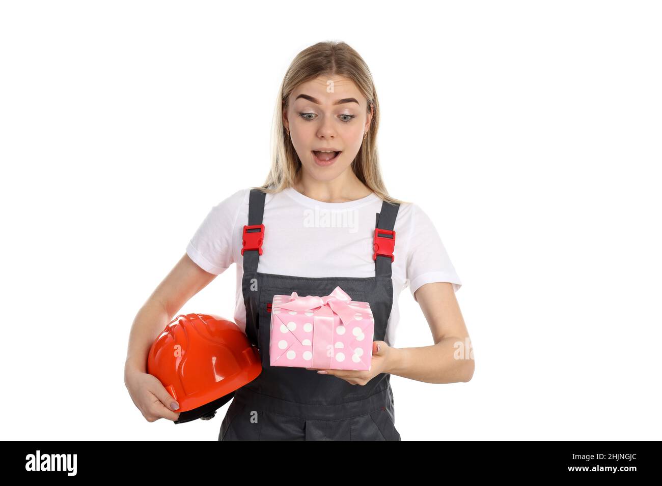 Builder girl with gift box isolated on white background Stock Photo - Alamy