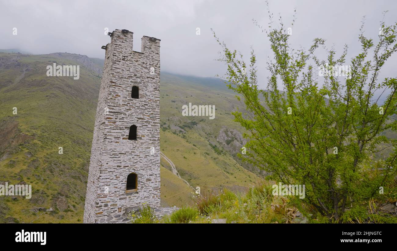 Stone towers of ancient buildings in mountains. Action. Old stone tower ...