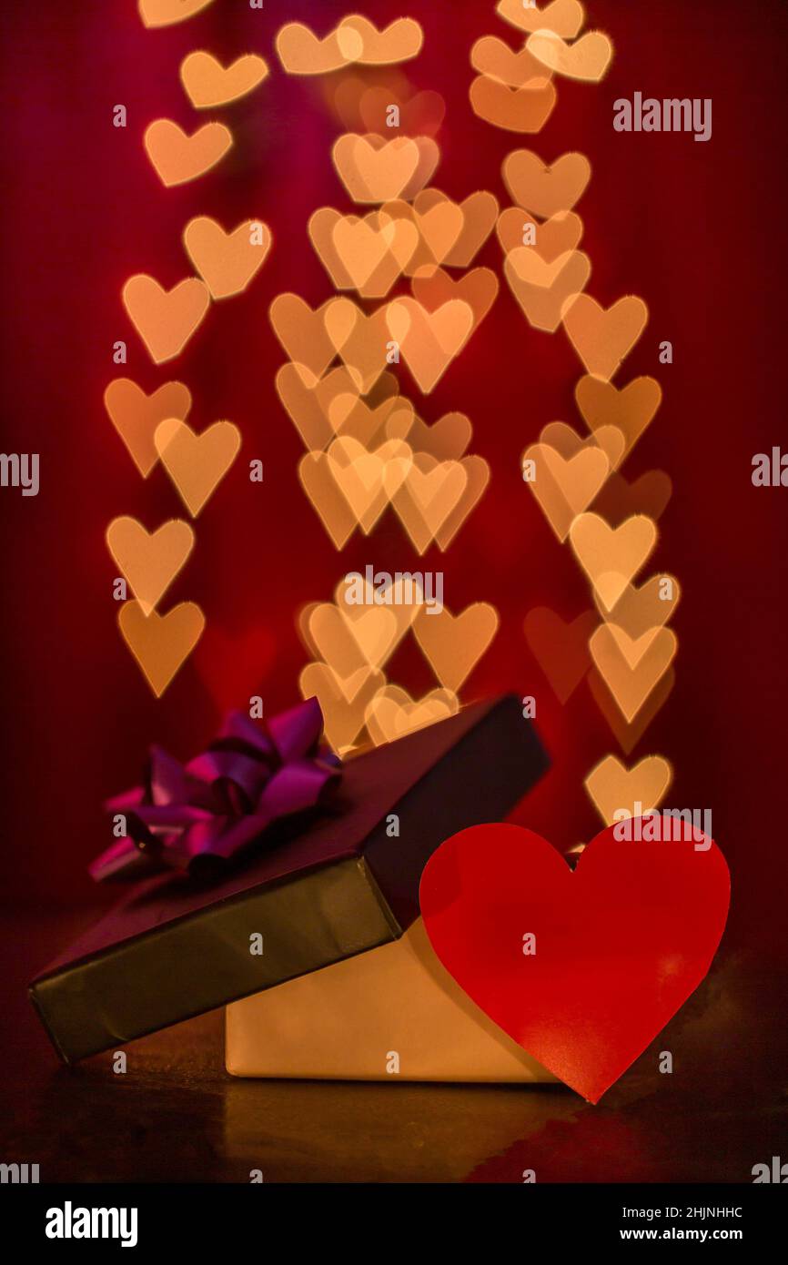 Open gift package and heart card with heart shaped bokeh lights Stock ...