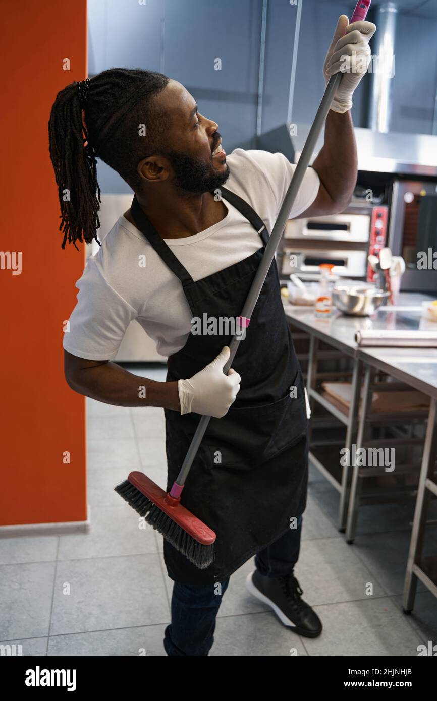 Funny chef cleaning floor at the restaurant Stock Photo - Alamy