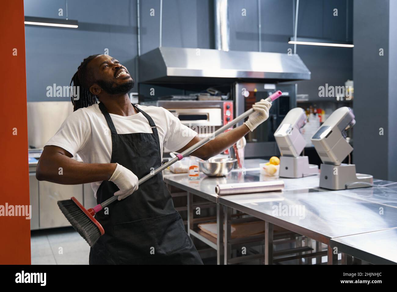 Funny chef cleaning floor at the kitchen Stock Photo - Alamy
