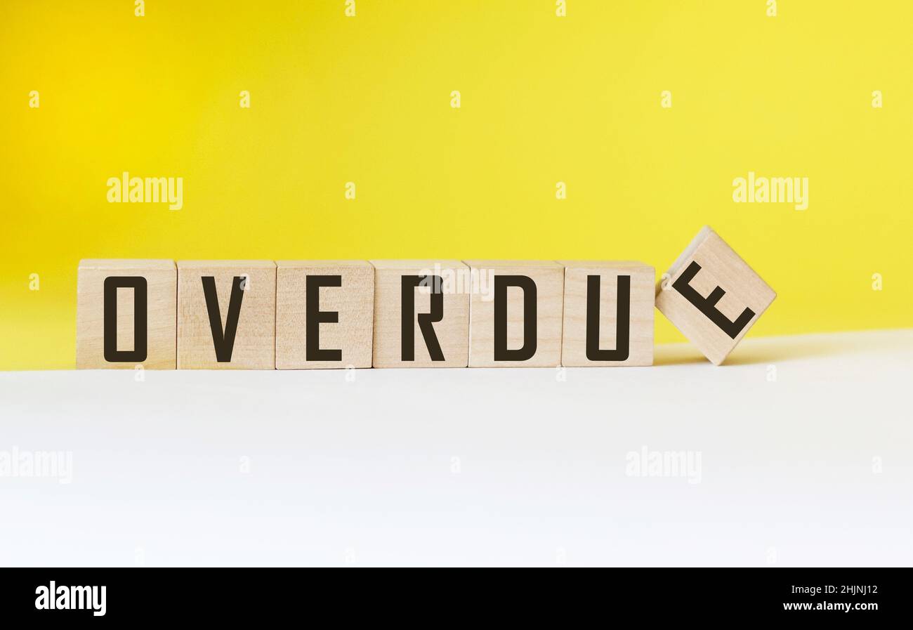 the word OVERDUE from building blocks on a white and yellow background ...