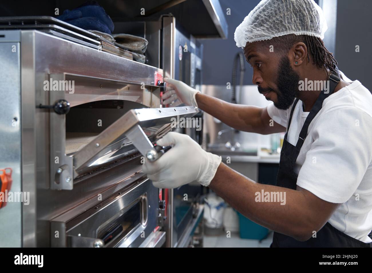 American chef hard working, baking food in restaurant Stock Photo - Alamy