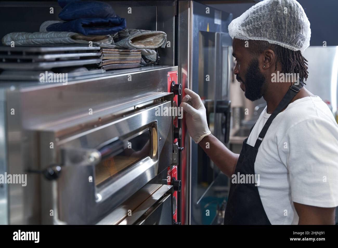 African male hard working, baking food in restaurant Stock Photo - Alamy