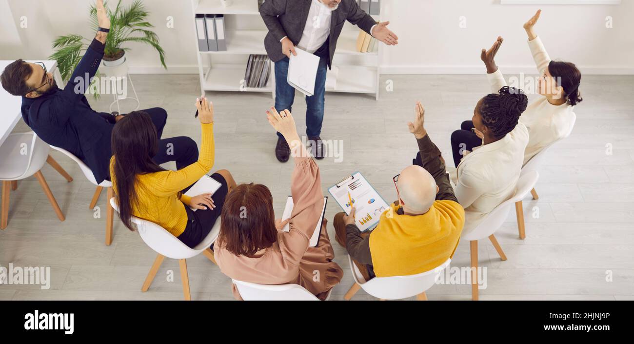 Business Coach Asking A Team Of People Questions During A Business