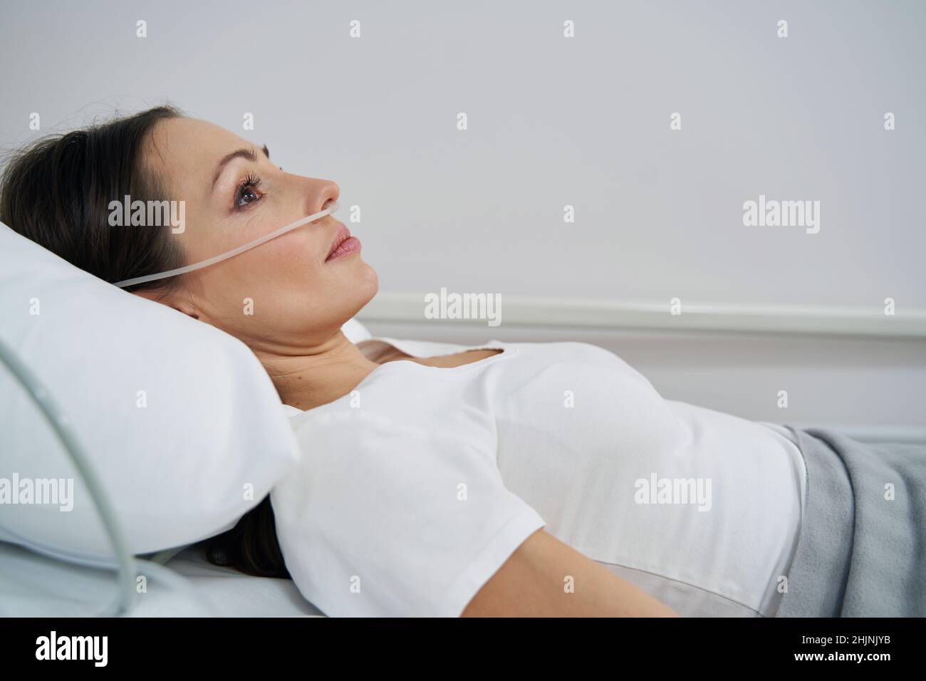 Ill young female patient undergoing oxygen therapy Stock Photo - Alamy