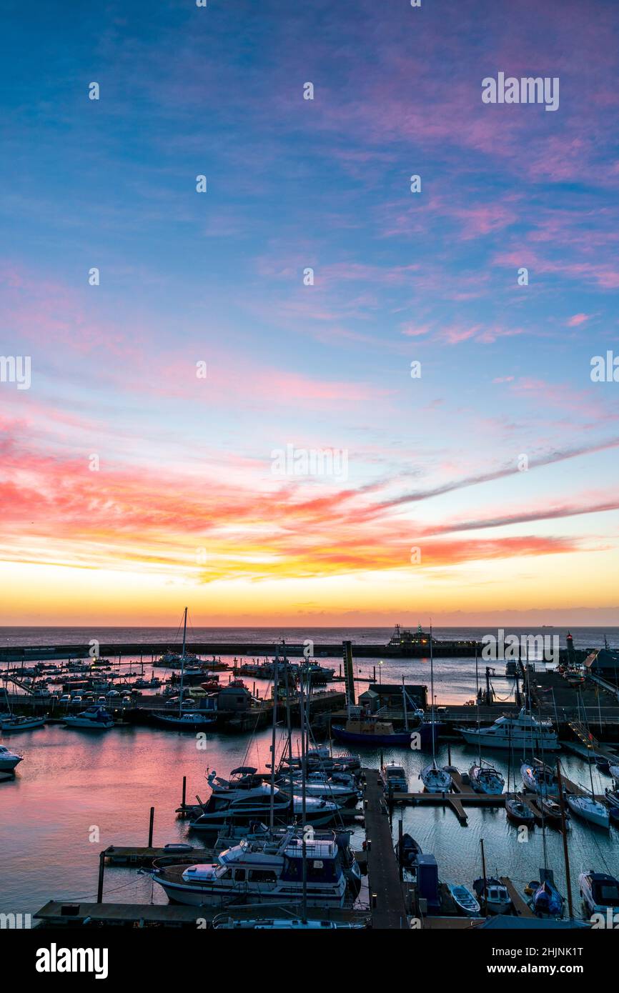 Colourful dawn sky over the English Channel and Ramsgate Royal Harbour ...