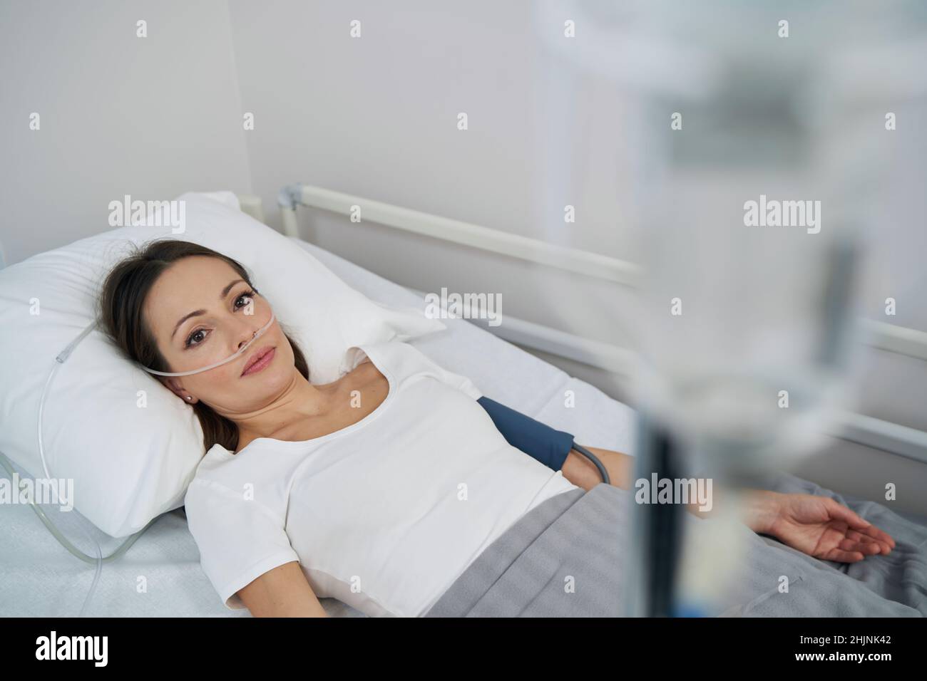 Young patient receiving medication through IV line Stock Photo - Alamy