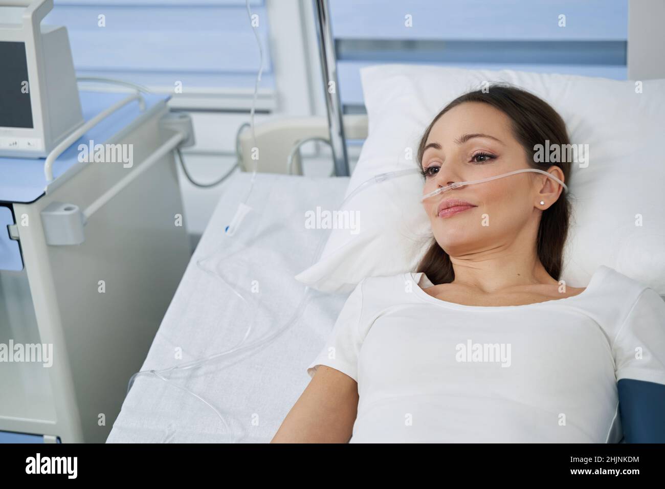 Woman undergoing oxygen therapy in hospital setting Stock Photo - Alamy