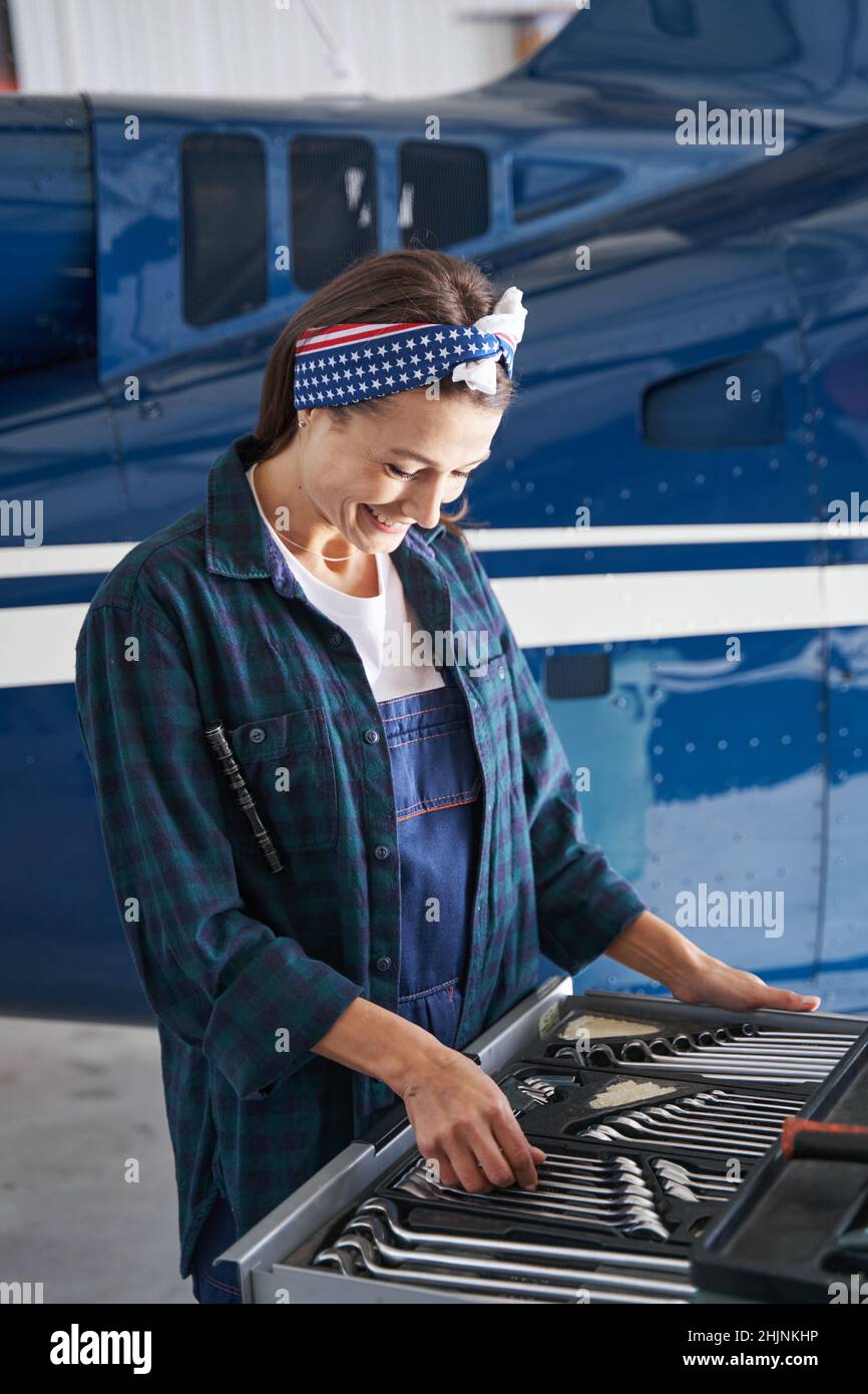Joyful laughing woman engineer with special equipments in hangar Stock ...