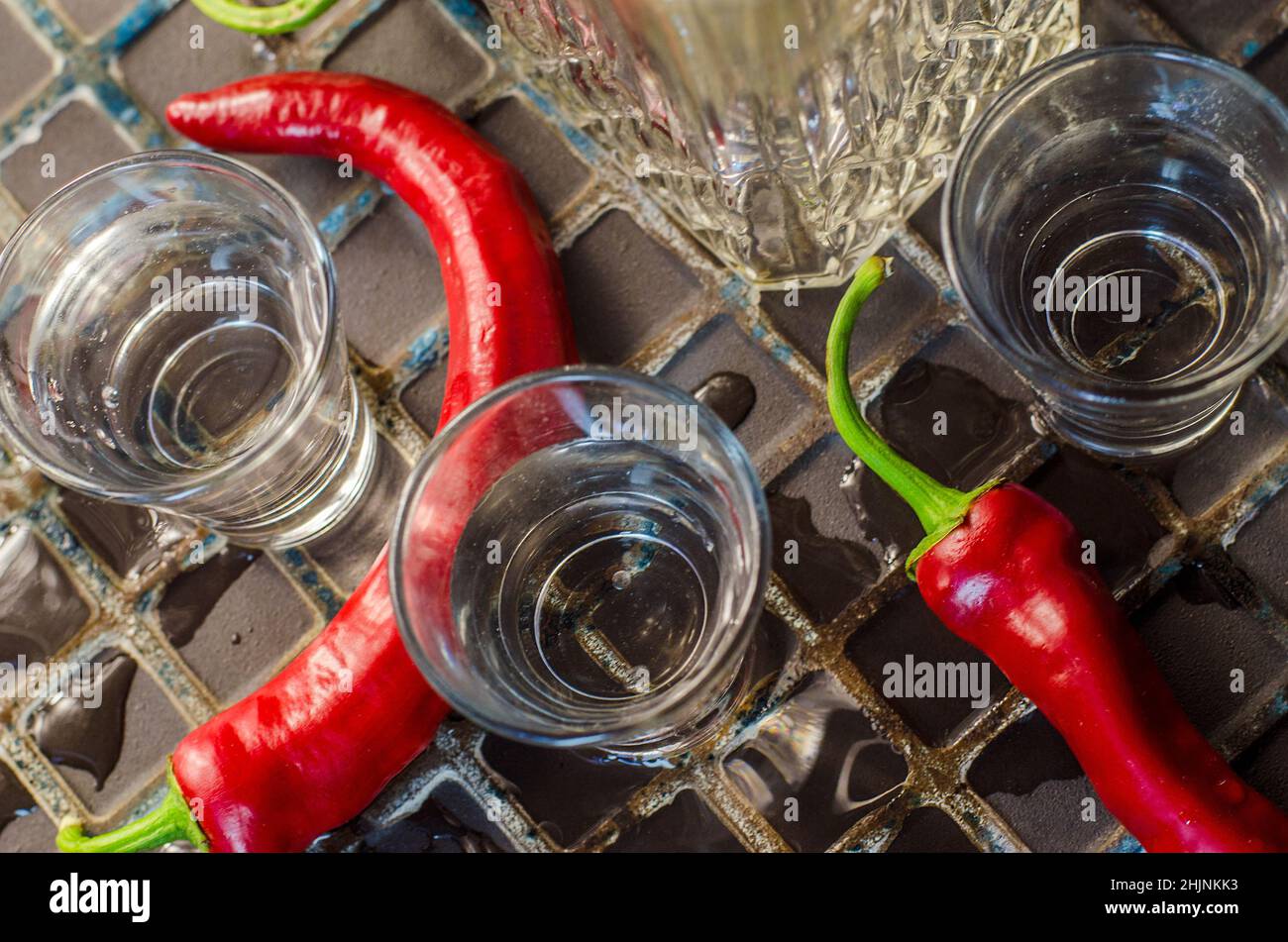 glass of vodka with hot peppers on dark background Stock Photo - Alamy