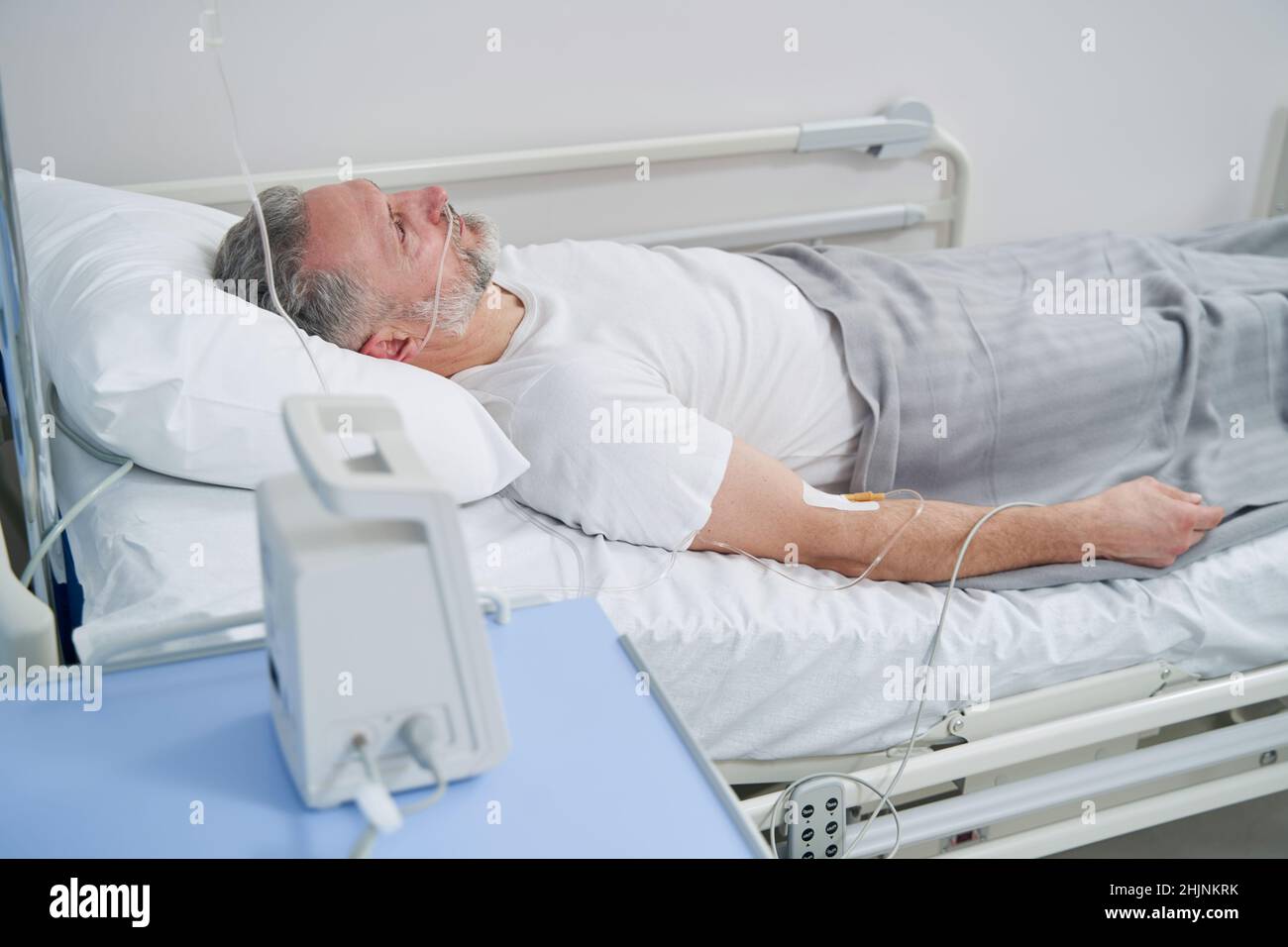 Recumbent Caucasian male patient undergoing intravenous therapy Stock ...