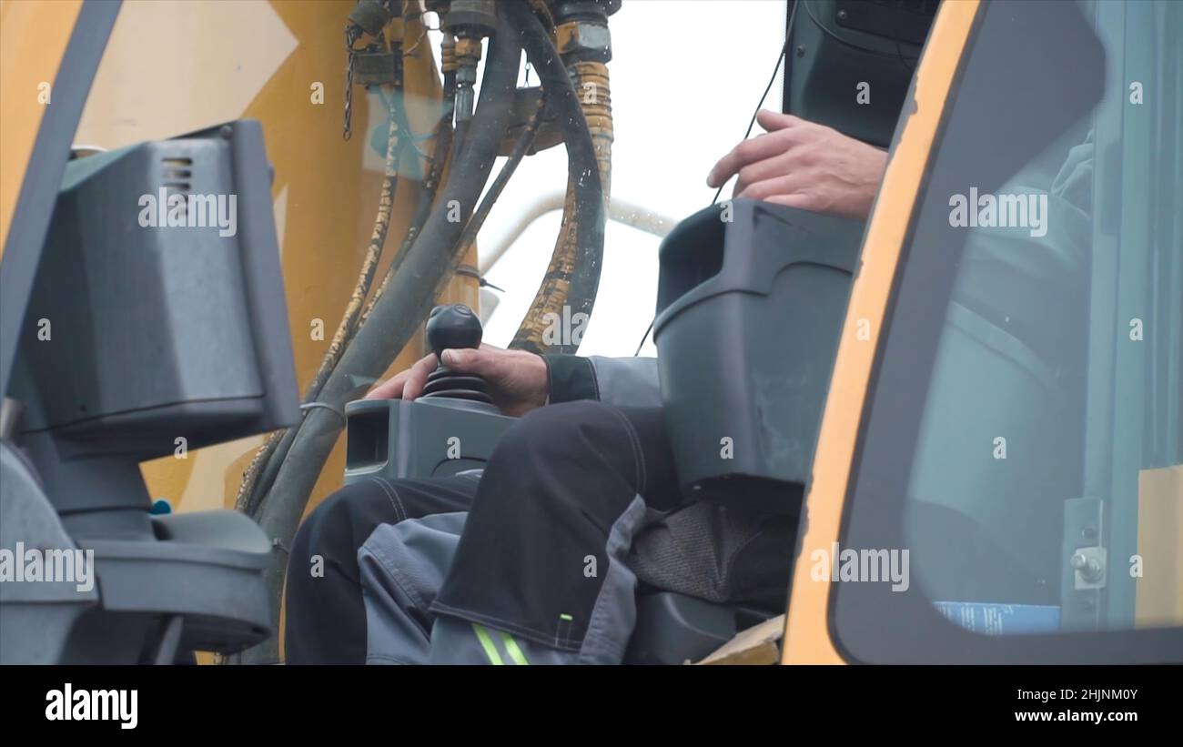 Engineer operator crane in action. Clip. Man in cabin controls the ...