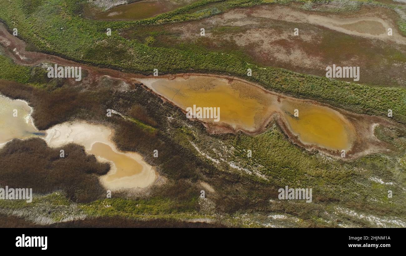 Top view of patterned dirty water from swamp. Shot. Acid brown water ...