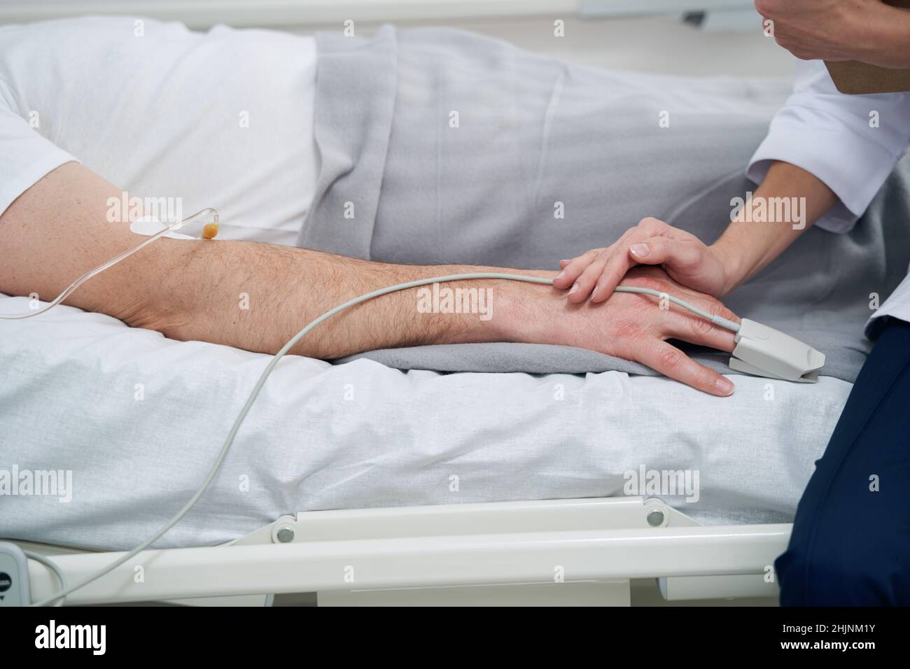 Physician monitoring patient oxygen saturation during intravenous ...