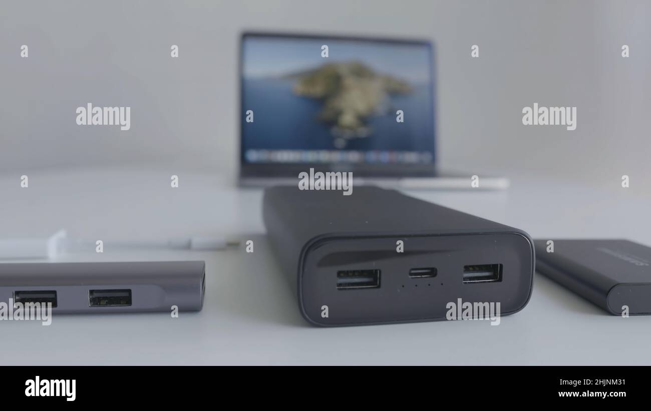 Set of external batteries on background of laptop. Action. Close-up of ...